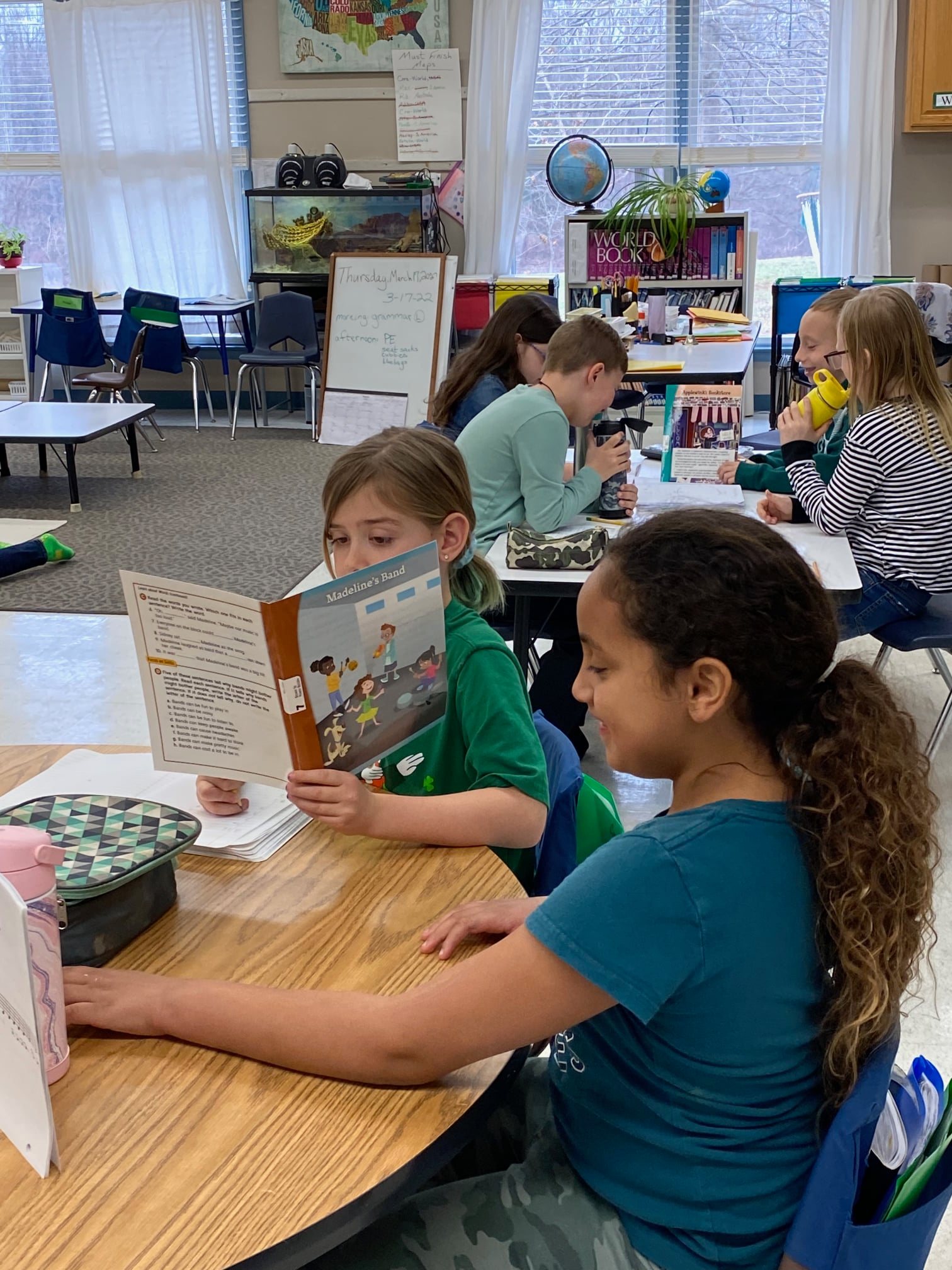 How's student's progress reported in a Montessori school?